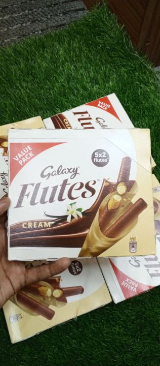 The image shows a box of Galaxy Flutes Cream wafer rolls. This is a ...