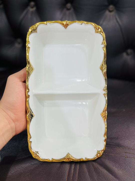 two-section serving dish, likely made of porcelain or ceramic, with a ...