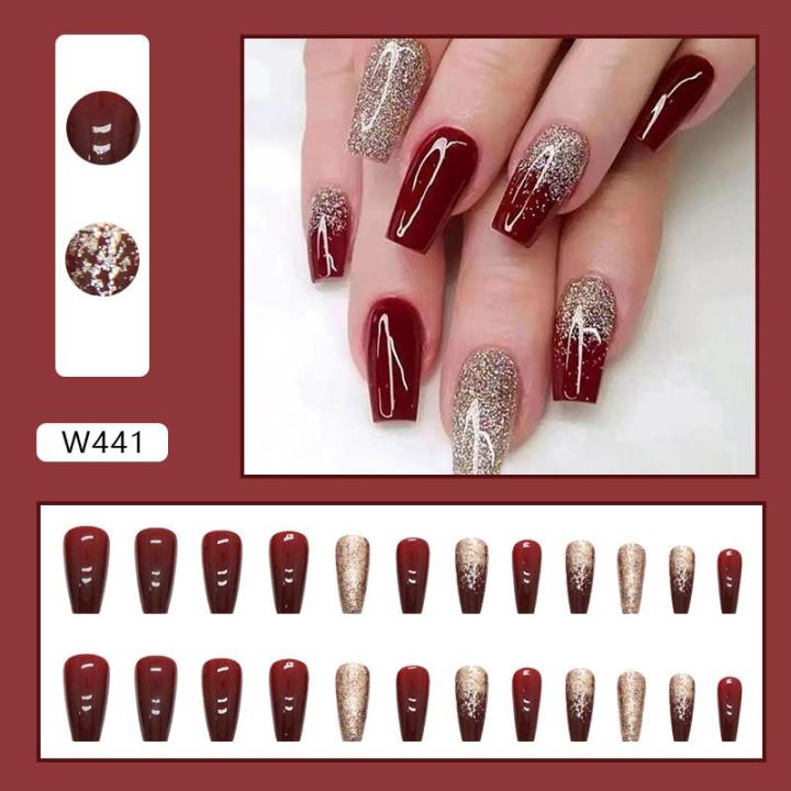 Dazzling coffin-shaped artificial nails with glue. Perfect deep red and ...