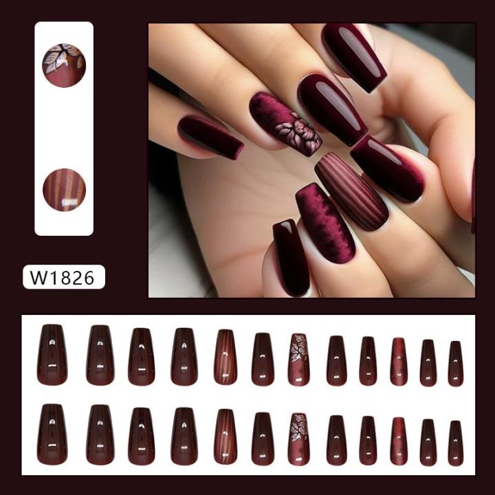 Luxurious maroon artificial nails with glue. Elegant matte and glossy ...